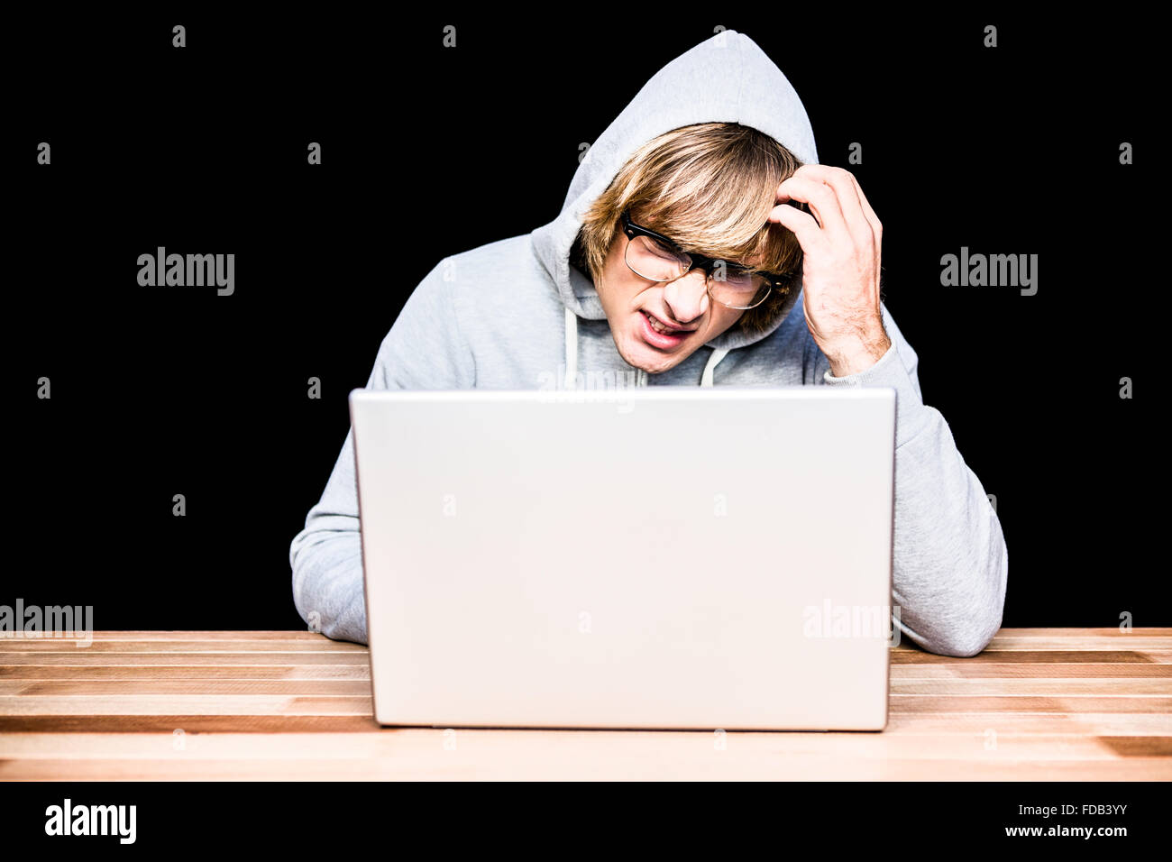 Young man using a laptop in secret hi-res stock photography and images ...