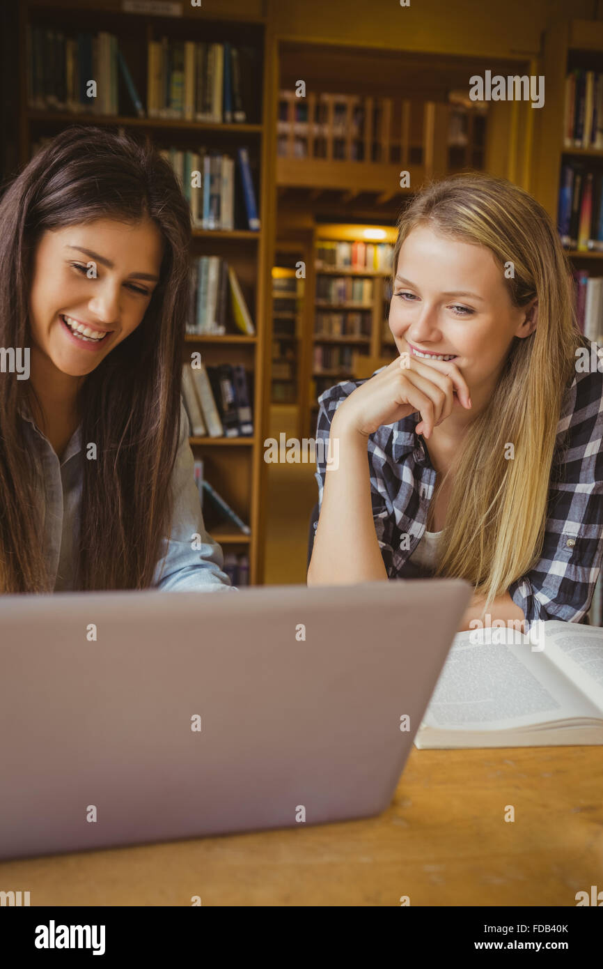 Smiling student working at library Stock Photo - Alamy