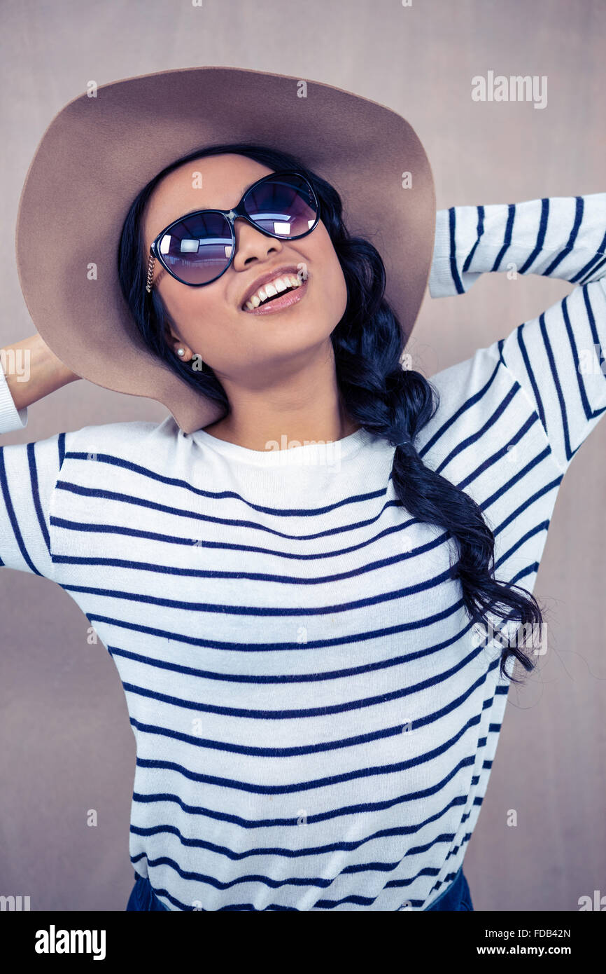 Smiling Asian woman with hat and sunglasses Stock Photo - Alamy