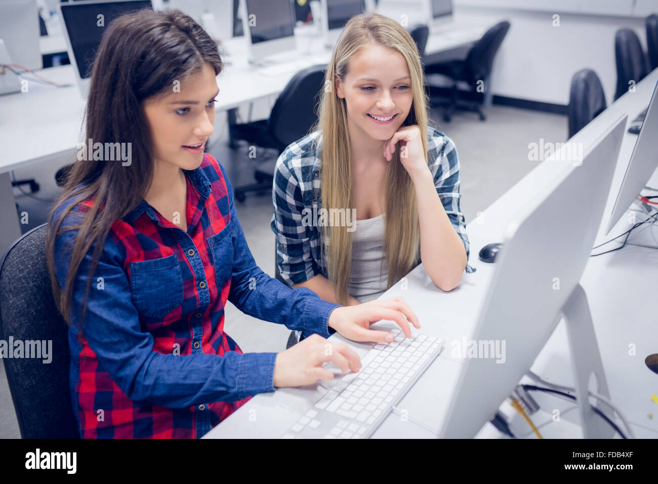 Smiling students using computer Stock Photo - Alamy