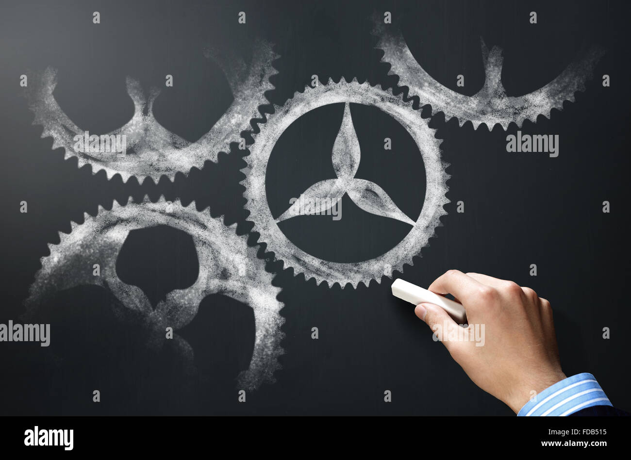 Businessman hand drawing with chalk gears mechanism as teamwork concept ...