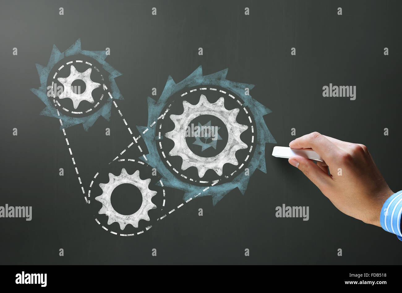 Businessman hand drawing with chalk gears mechanism as teamwork concept ...