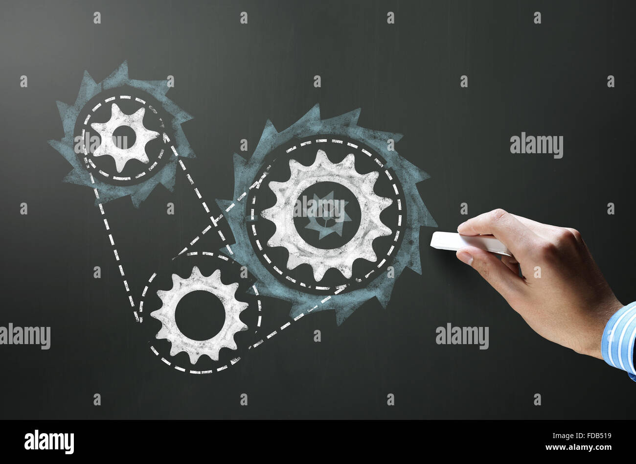 Businessman hand drawing with chalk gears mechanism as teamwork concept ...