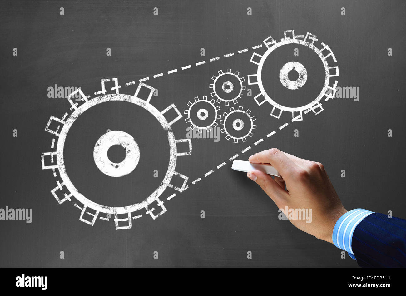 Businessman hand drawing with chalk gears mechanism as teamwork concept ...