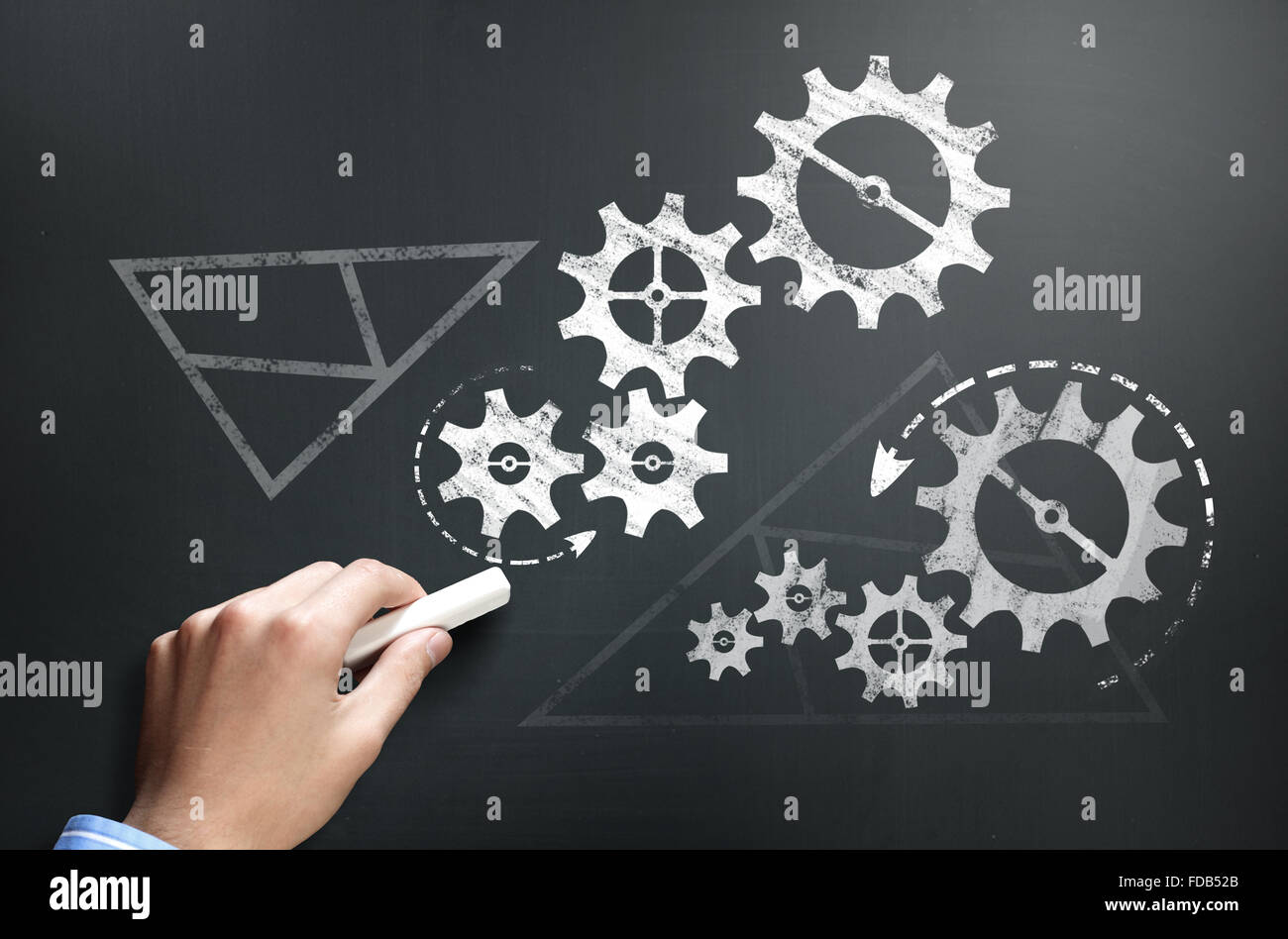 Businessman hand drawing with chalk gears mechanism as teamwork concept ...