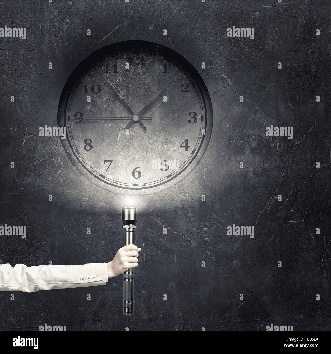 Hand of business person shine with flashlight on clock Stock Photo - Alamy