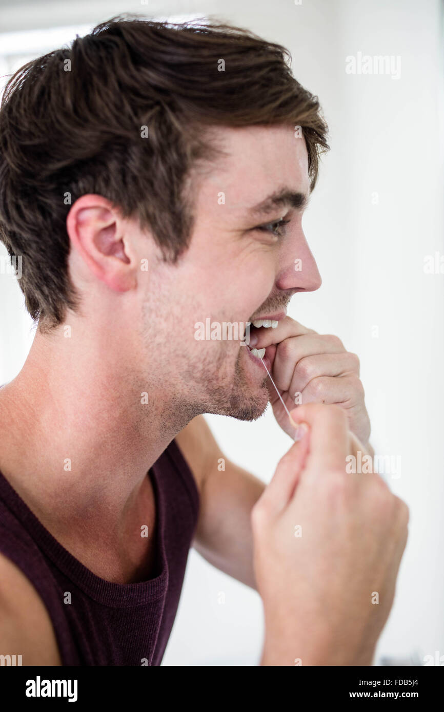 Handsome man cleaning his teeth Stock Photo - Alamy