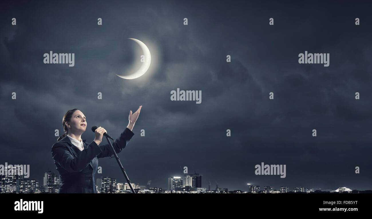 Woman reporter with microphone gesturing with hand hi-res stock ...