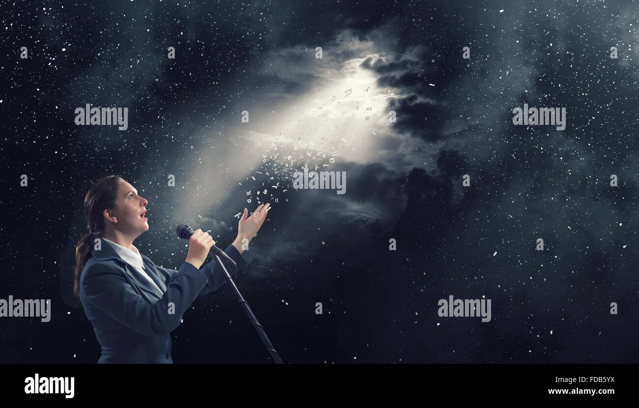 Woman reporter with microphone gesturing with hand Stock Photo - Alamy