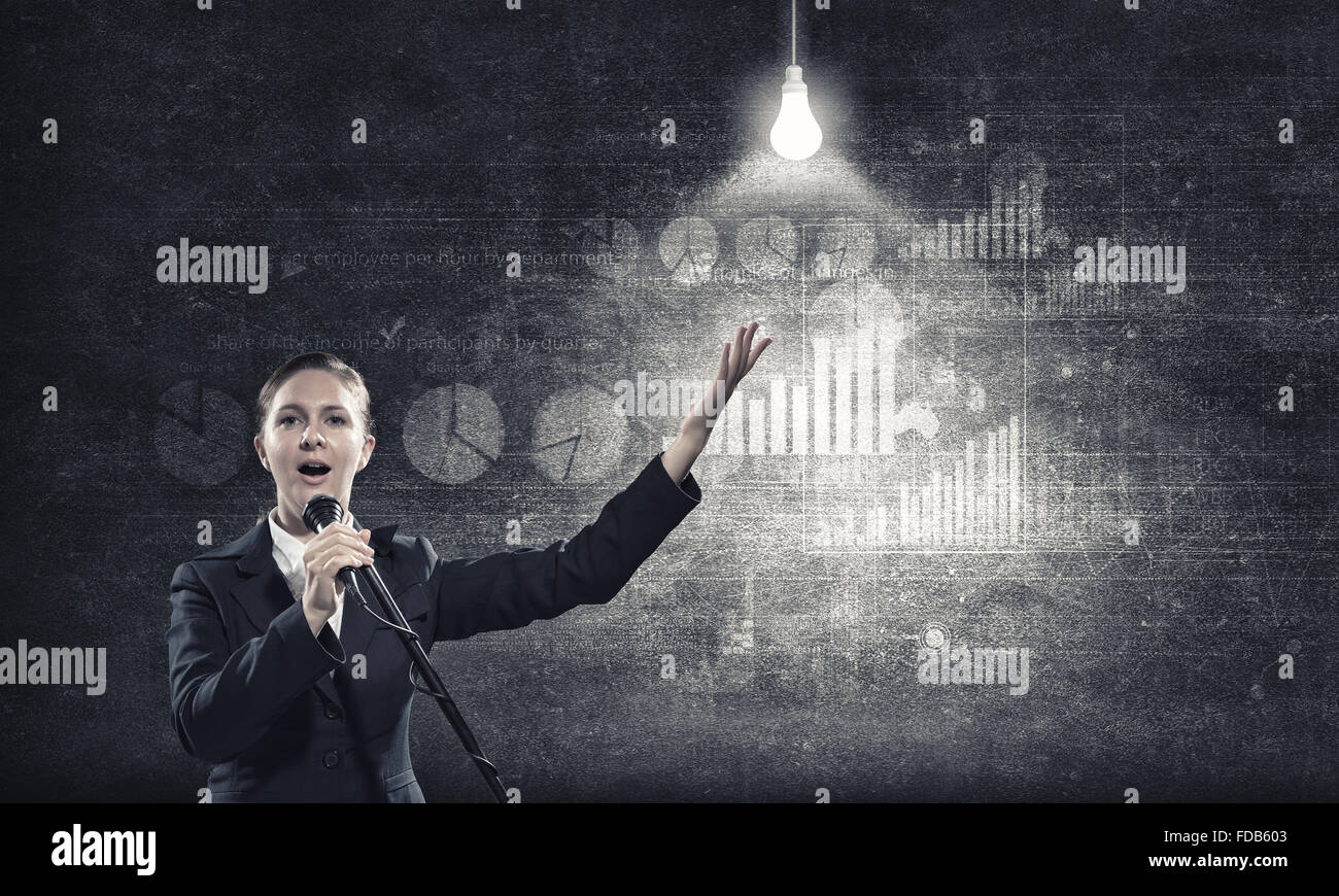 Woman reporter with microphone gesturing with hand Stock Photo - Alamy