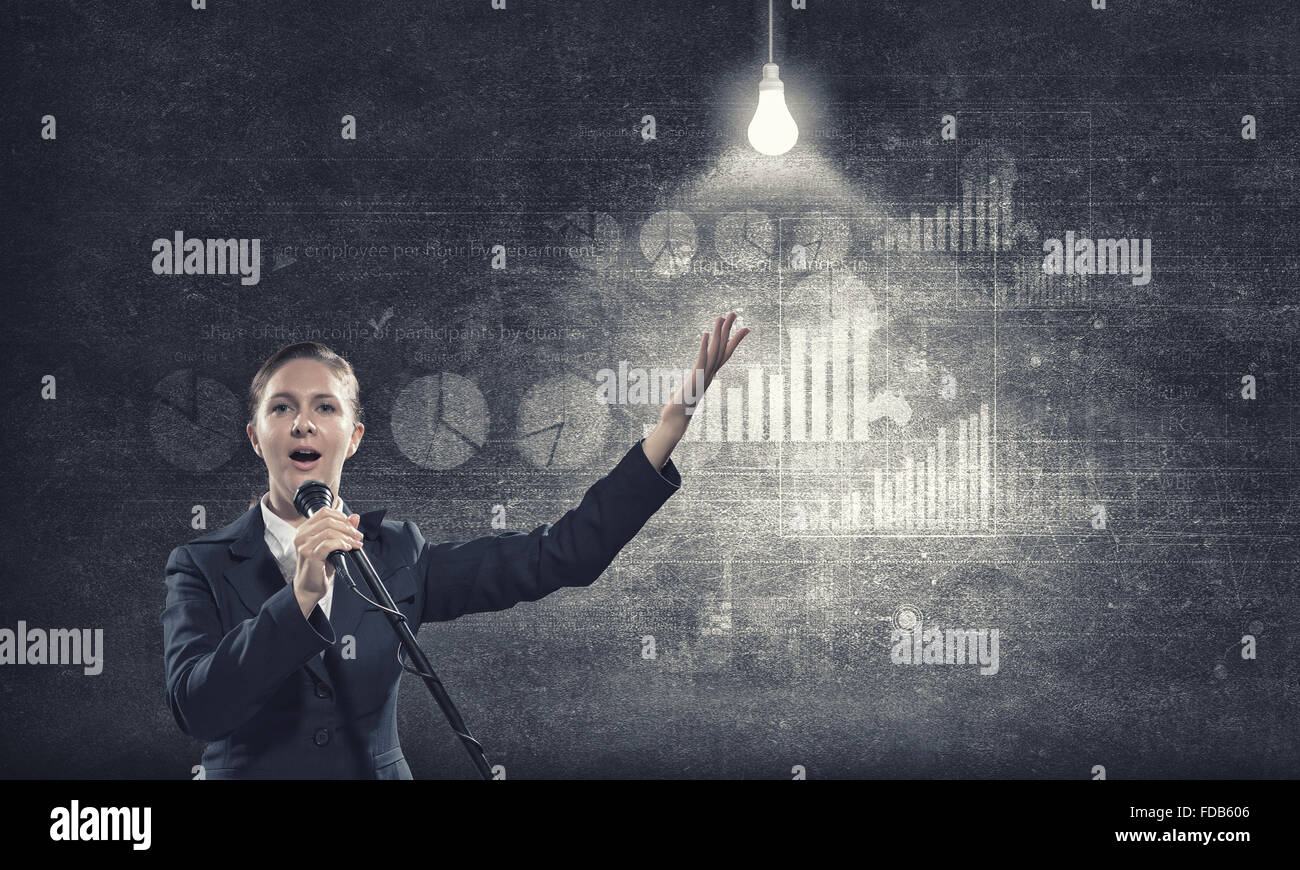 Woman reporter with microphone gesturing with hand Stock Photo - Alamy