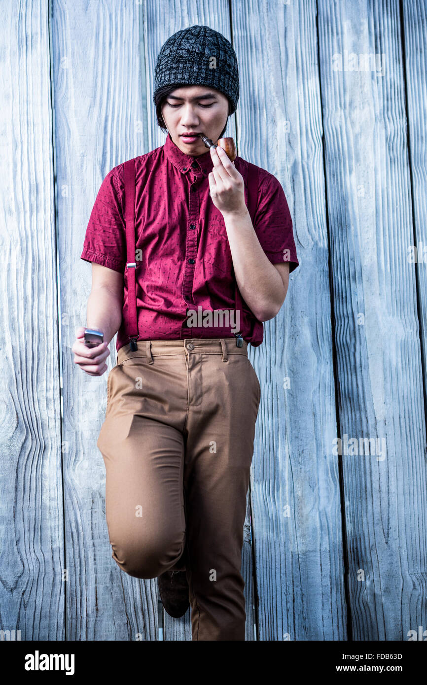 Hipster smoking pipe with a lighter Stock Photo - Alamy