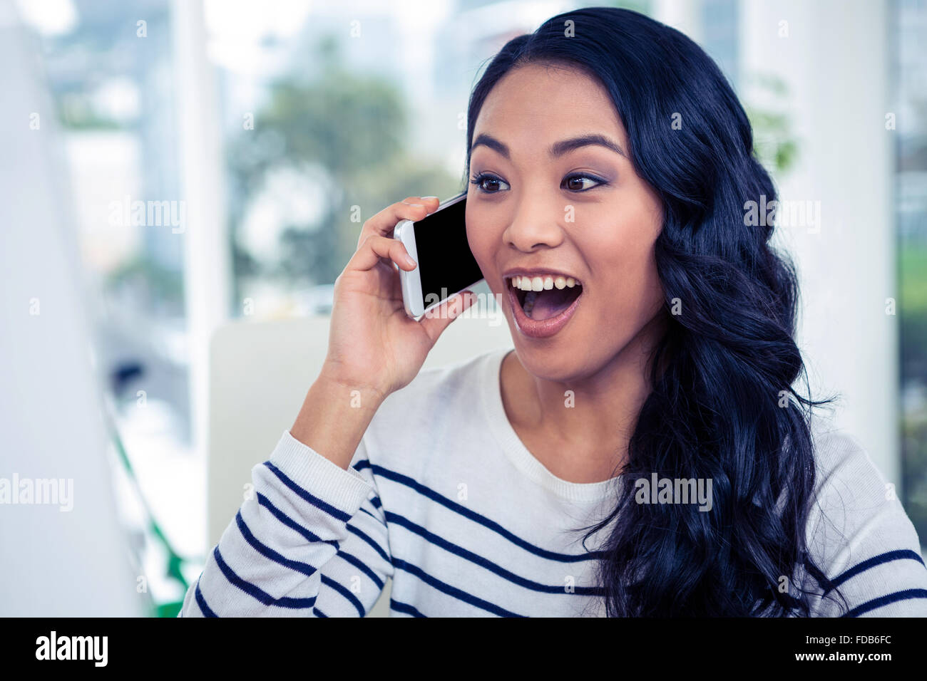 Surprised Asian woman on phone call Stock Photo - Alamy
