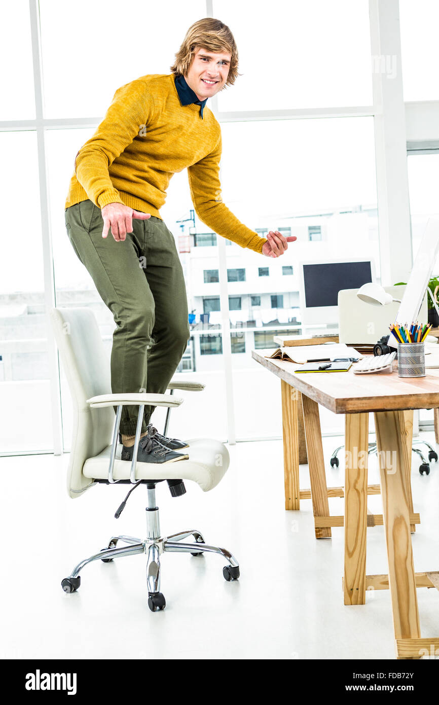Happy businessman standing on chair hi-res stock photography and images ...