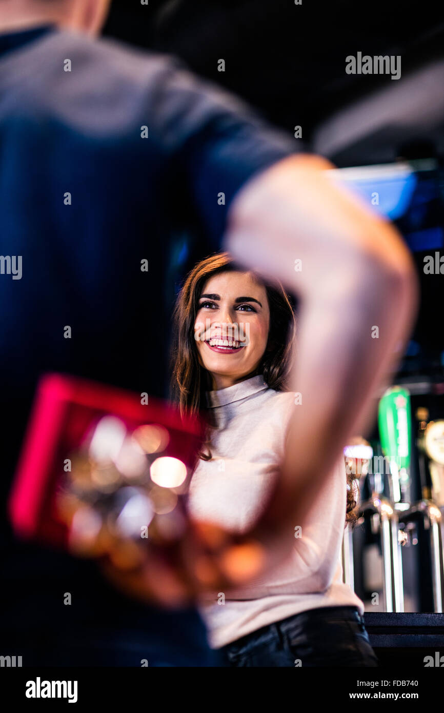 Man hiding gift box behind back Stock Photo - Alamy