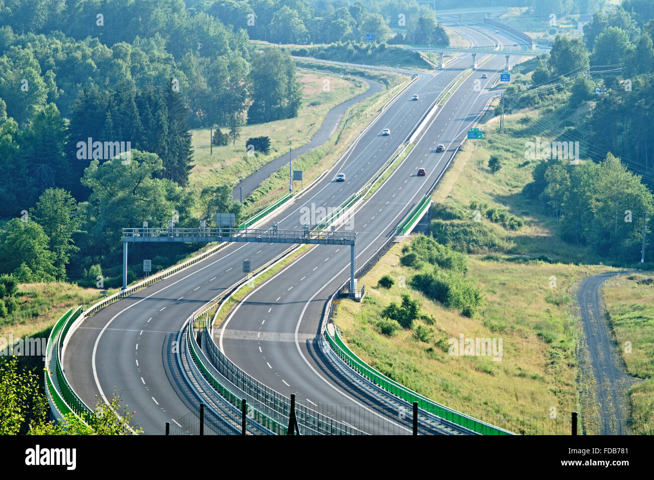 The highway between forests in the landscape, on the highway electronic ...