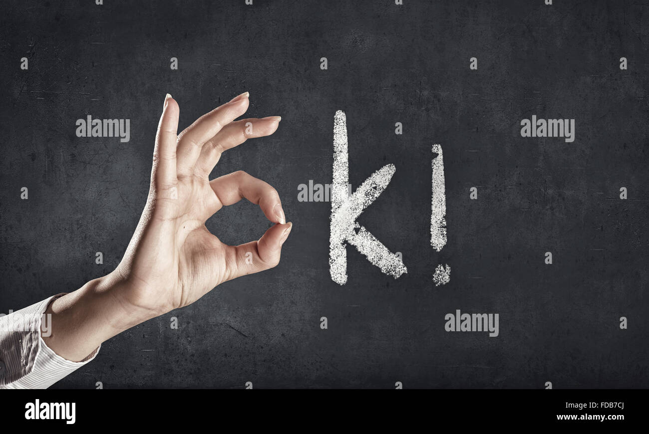 Hand showing ok gesture as part of word Stock Photo - Alamy