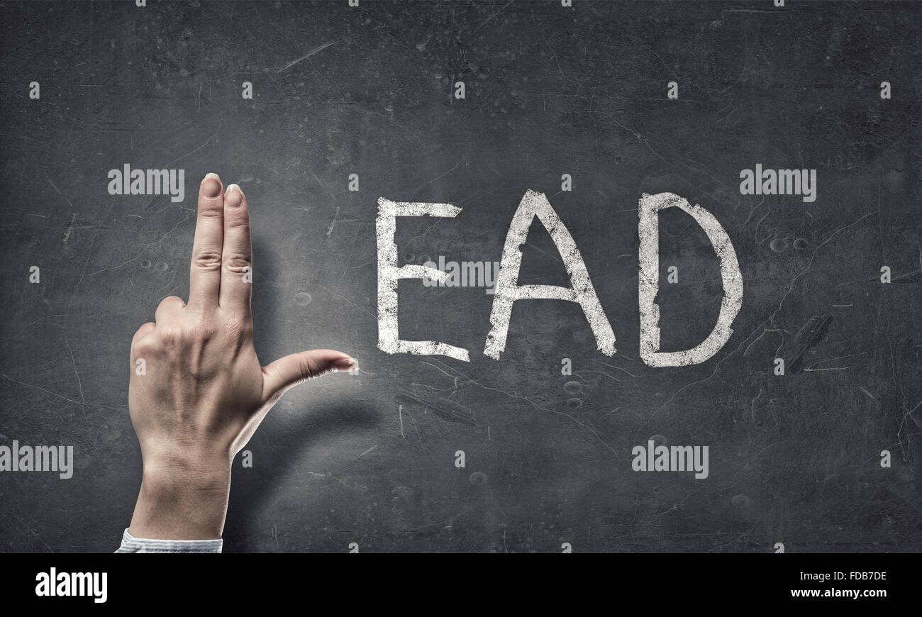 Word Lead Written On Wall And Fingers Instead Of Letter L Stock Photo word-lead-written-on-wall-and-fingers-instead-of-letter-l-stock-photo