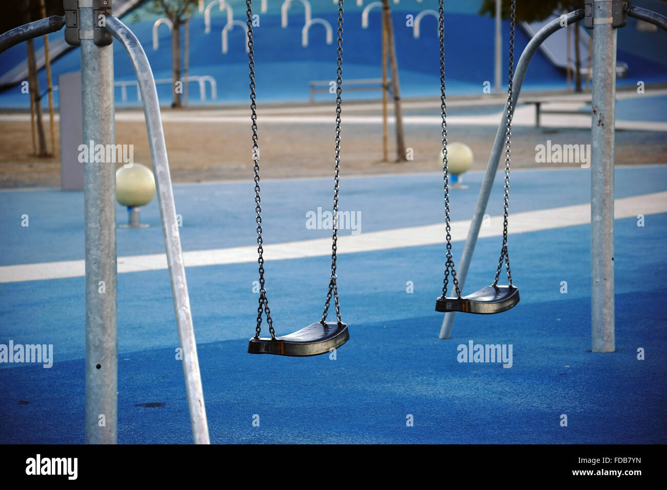 Modern playground with swings Stock Photo - Alamy