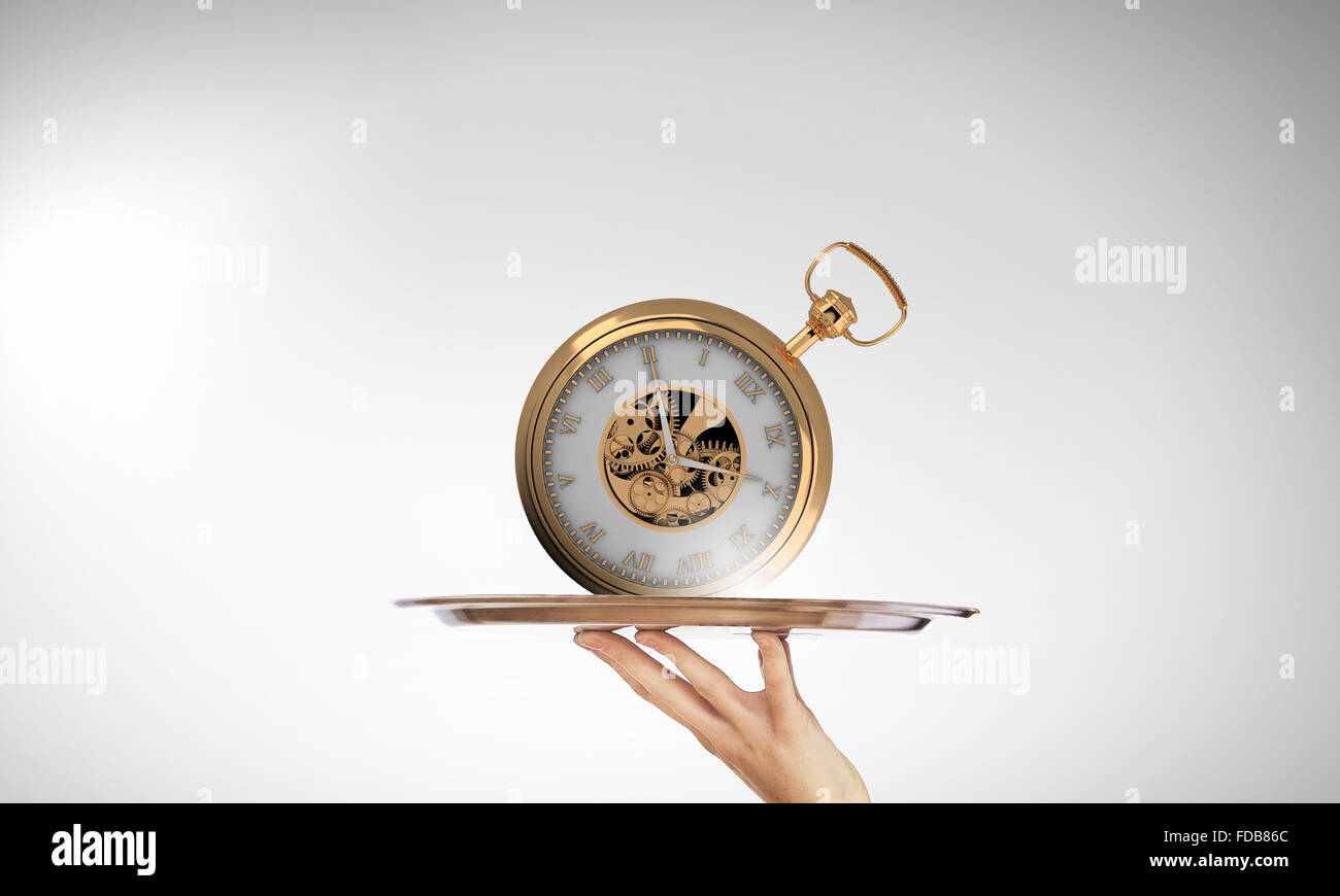 Waiter holding silver platter with old pocket watch Stock Photo - Alamy
