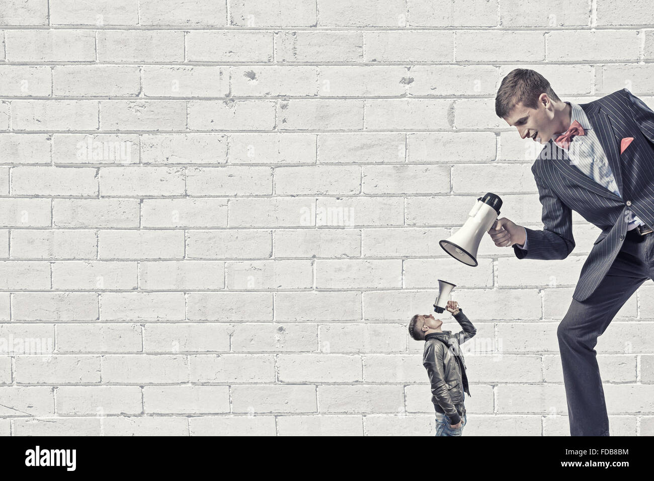 Aggressive businessman screaming in megaphone on his colleague Stock ...