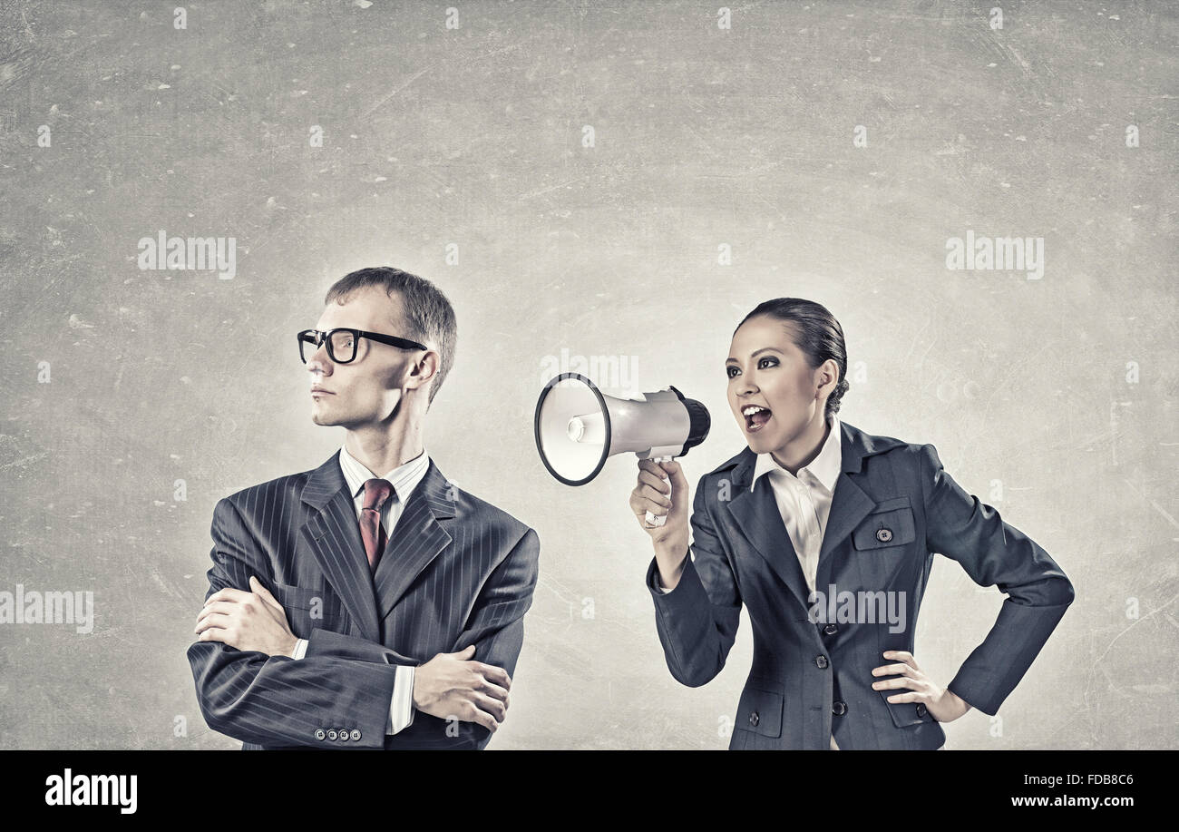 Aggressive businesswoman screaming in megaphone on her colleague Stock ...