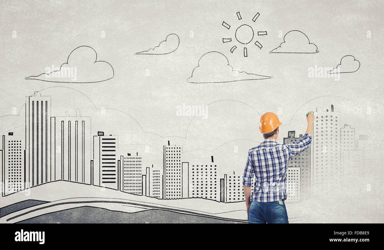 Rear view of engineer drawing project of business district Stock Photo ...