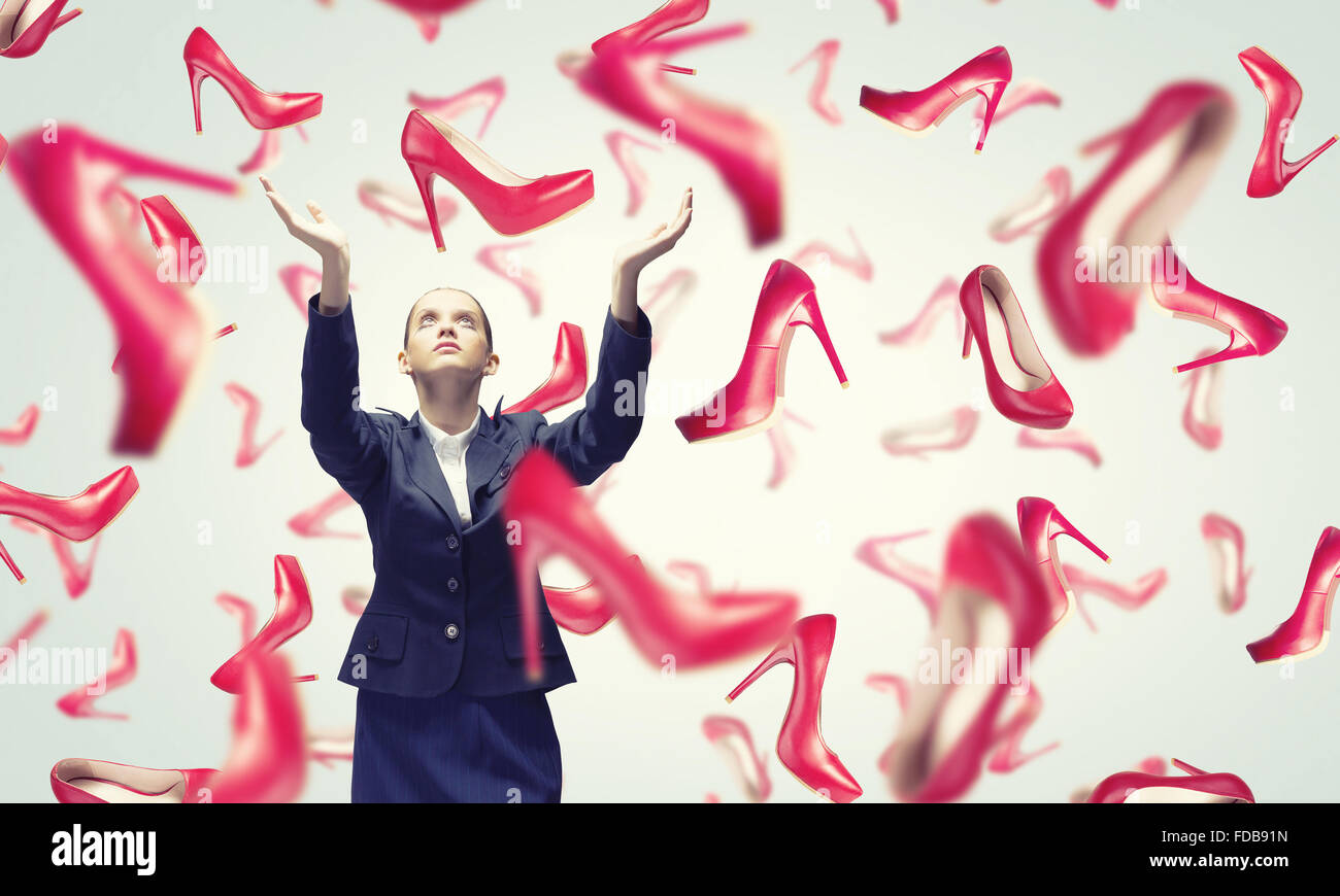 Beautiful young woman in suit and falling shoes Stock Photo - Alamy