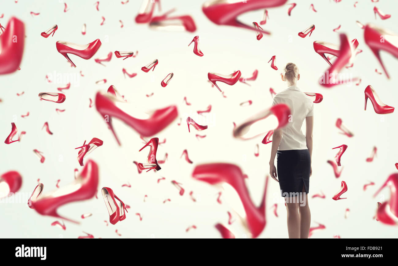 Beautiful young woman in suit and falling shoes Stock Photo - Alamy