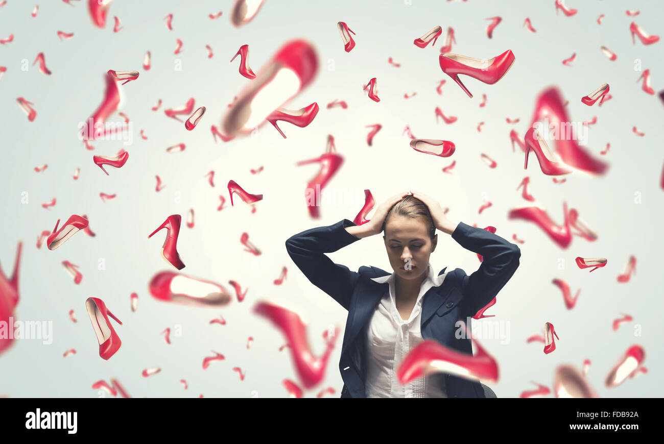 Beautiful young woman in suit and falling shoes Stock Photo - Alamy
