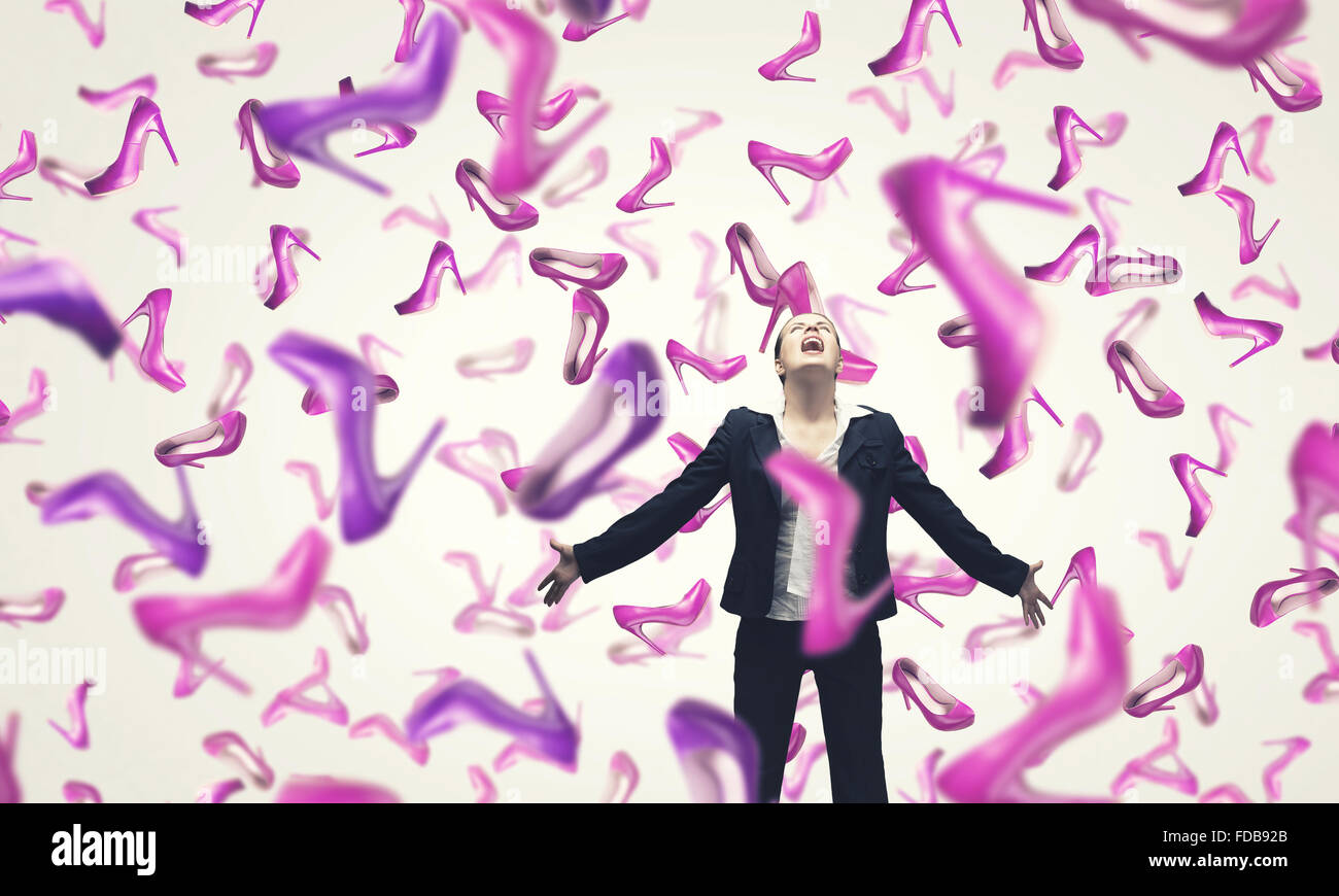 Beautiful young woman in suit and falling shoes Stock Photo - Alamy