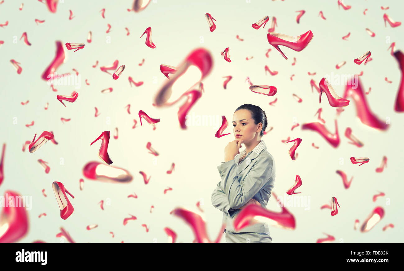 Beautiful young woman in suit and falling shoes Stock Photo - Alamy