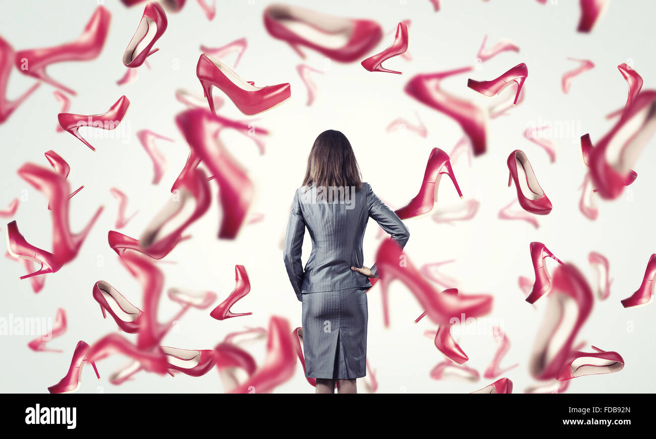 Beautiful young woman in suit and falling shoes Stock Photo - Alamy