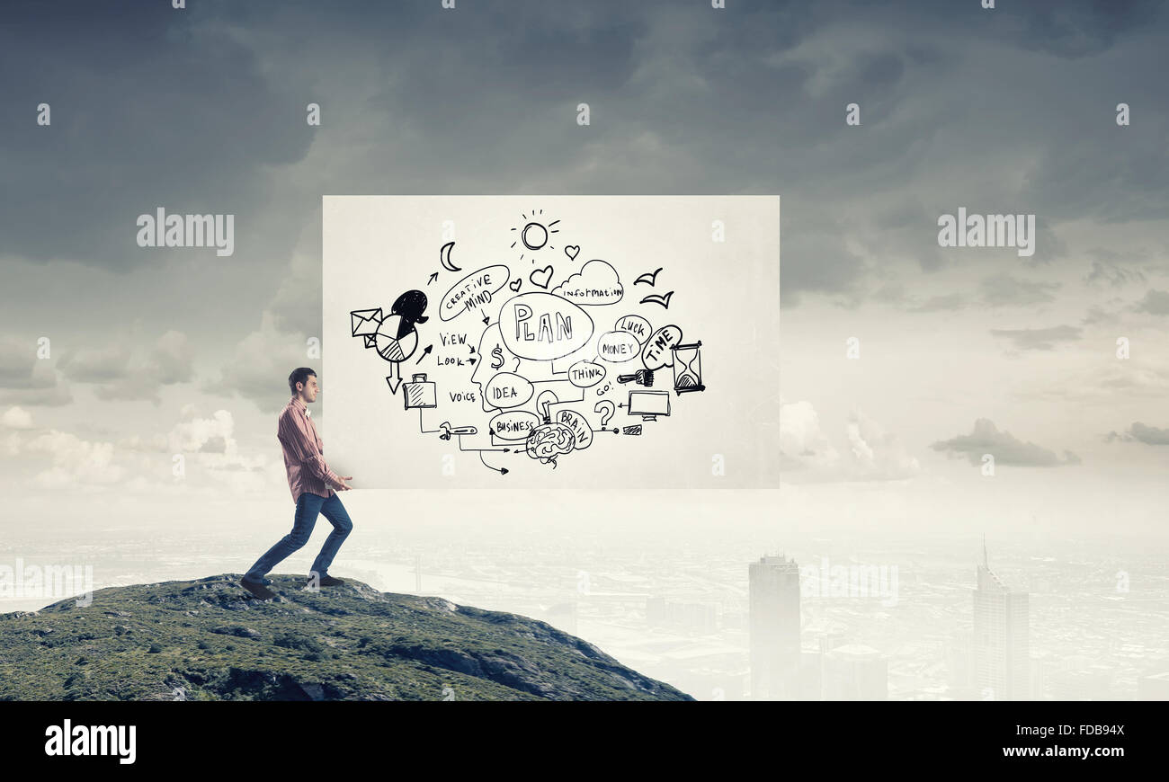 Young man carrying banner with his great business plan Stock Photo - Alamy