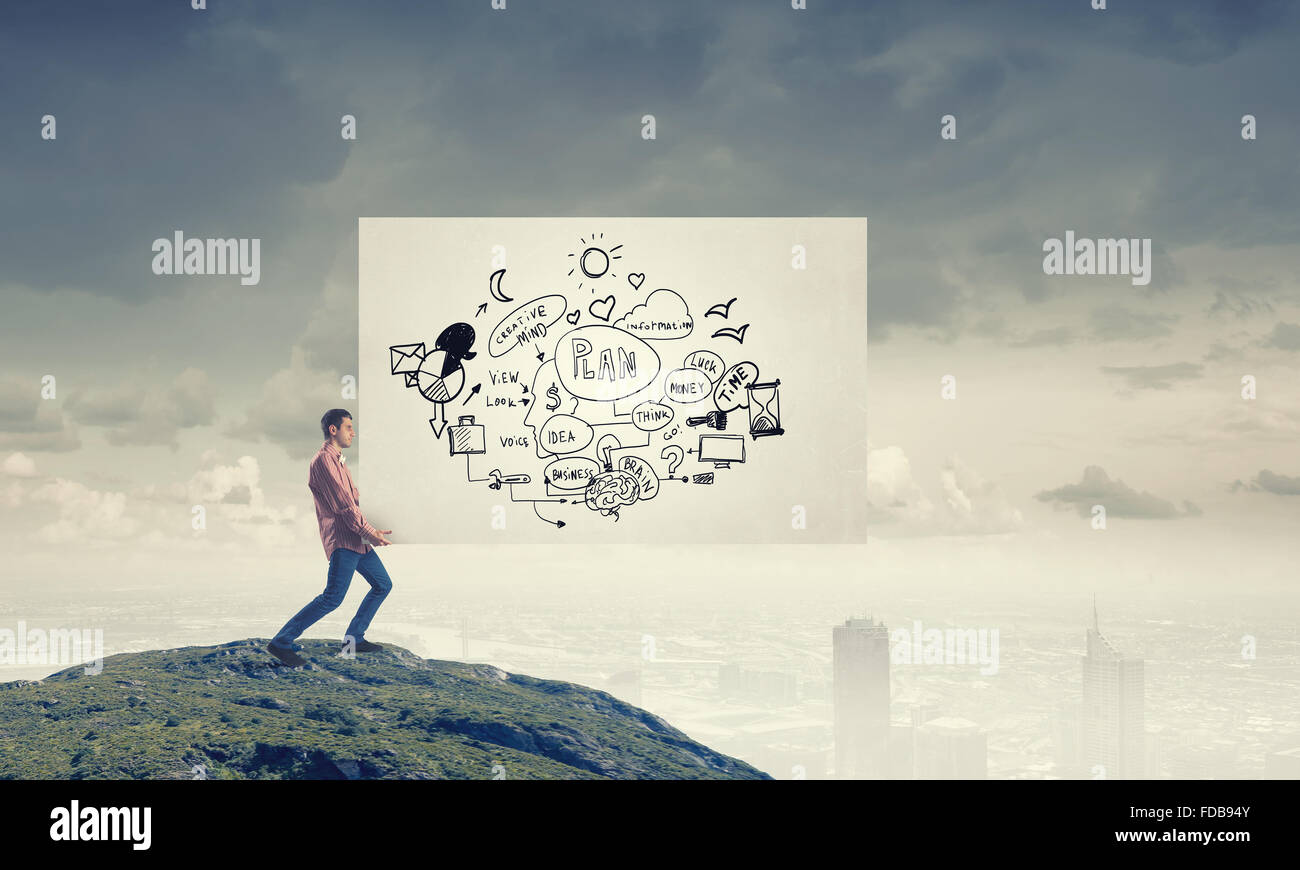 Young man carrying banner with his great business plan Stock Photo - Alamy