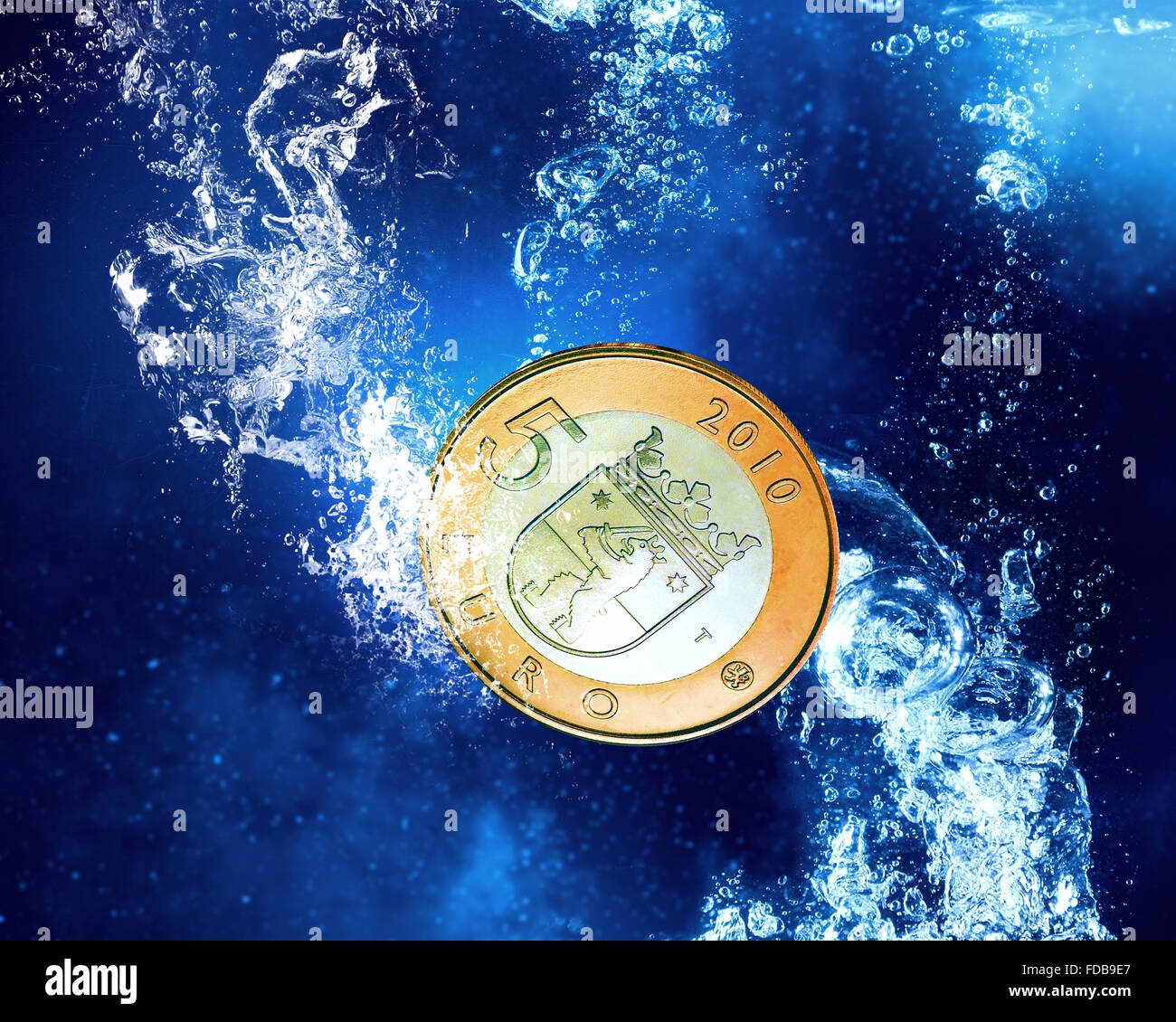 Five euro coin in clear blue water Stock Photo - Alamy