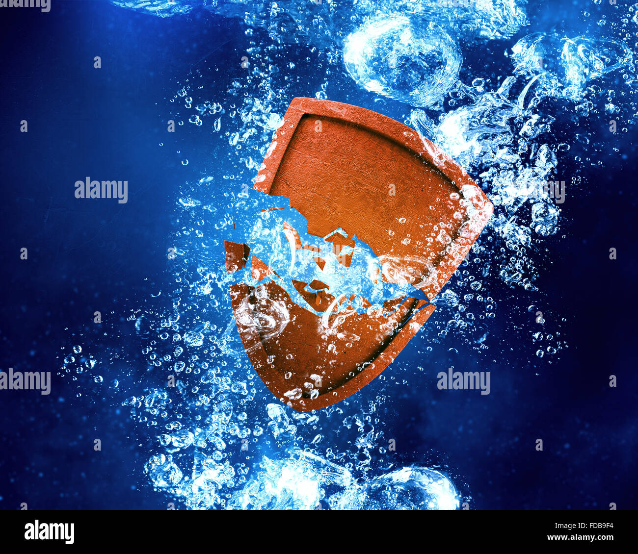 Shield sinking and dissolving in clear blue water Stock Photo - Alamy