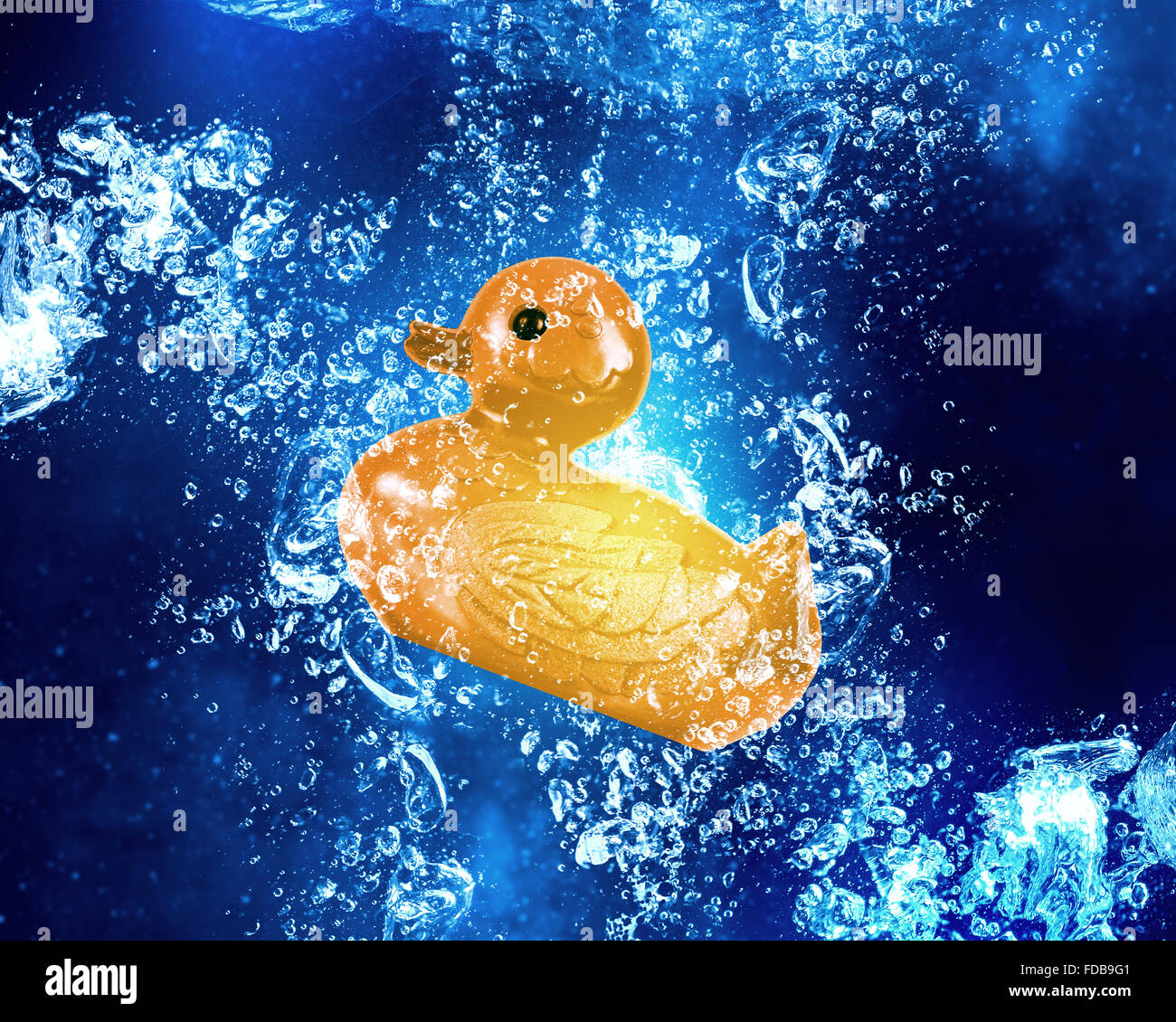 Yellow rubber duck sinking in clear blue water Stock Photo - Alamy
