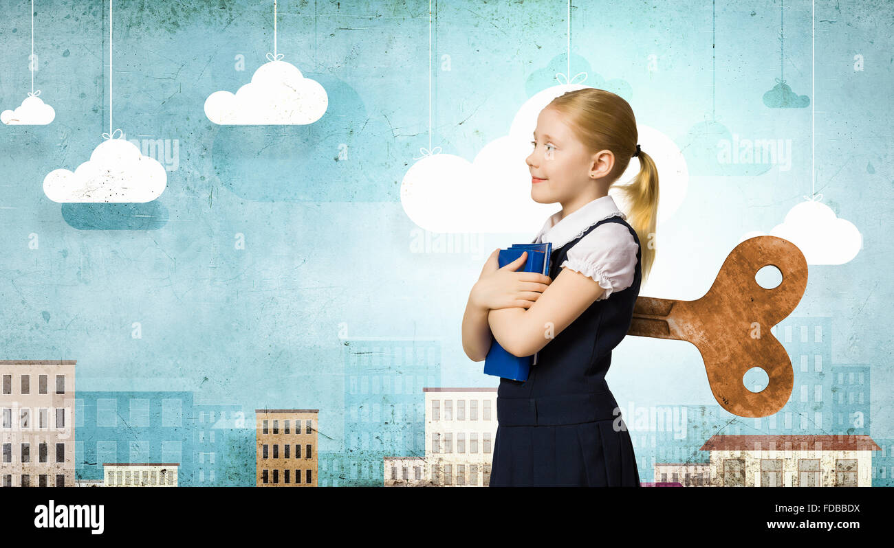 Little cute active girl with key on back Stock Photo - Alamy