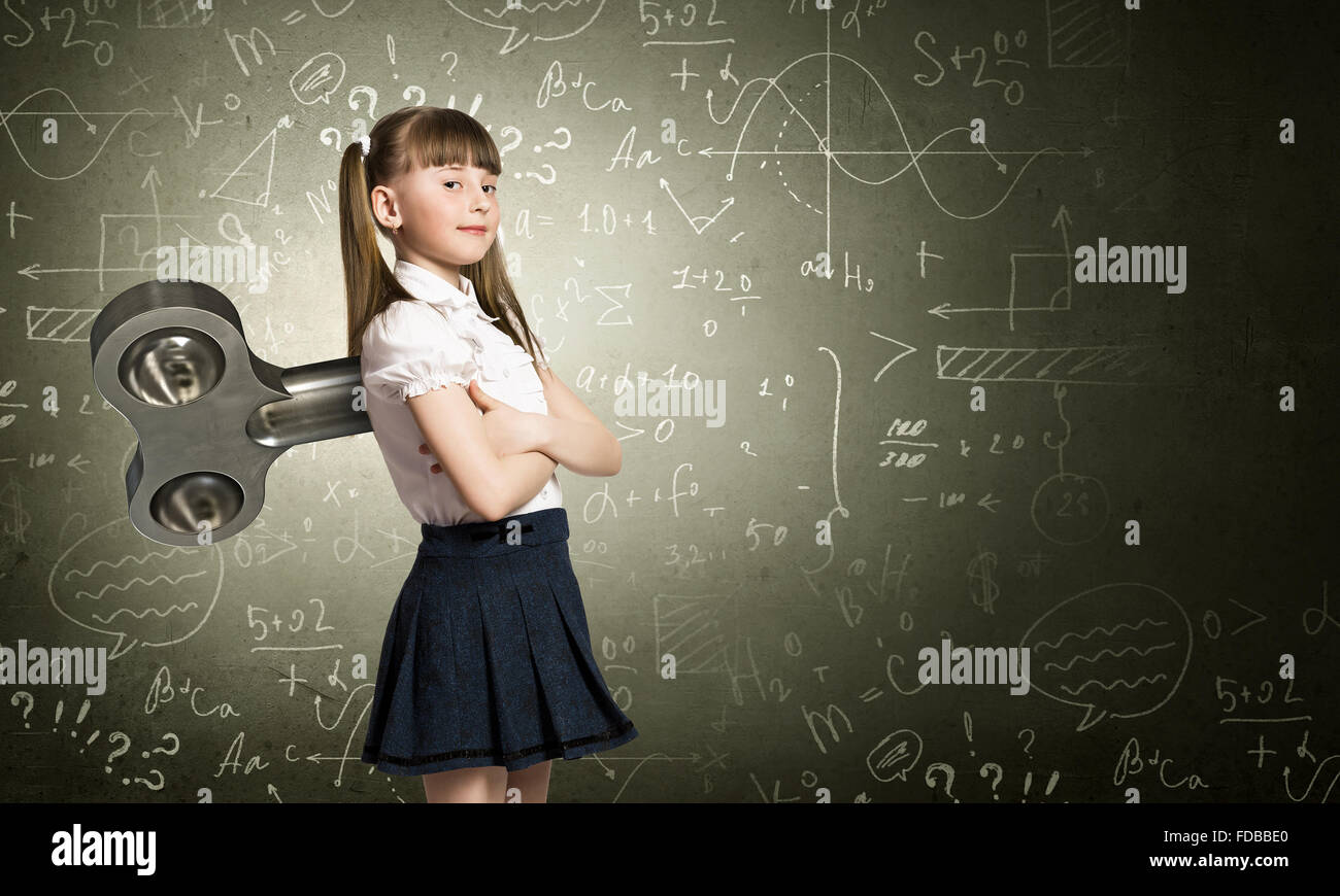 Little cute active girl with key on back Stock Photo - Alamy