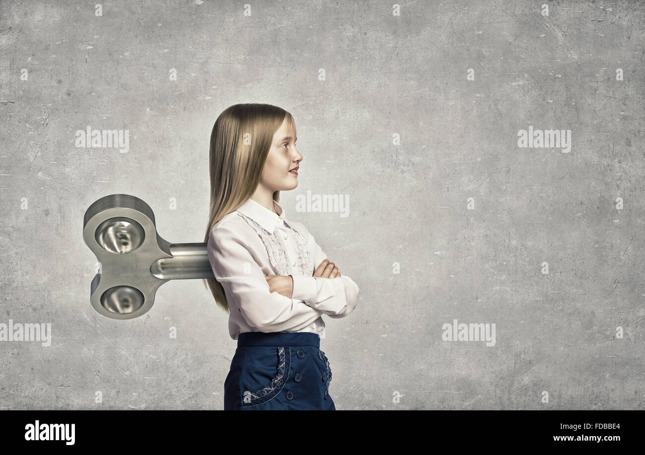 Little cute active girl with key on back Stock Photo - Alamy