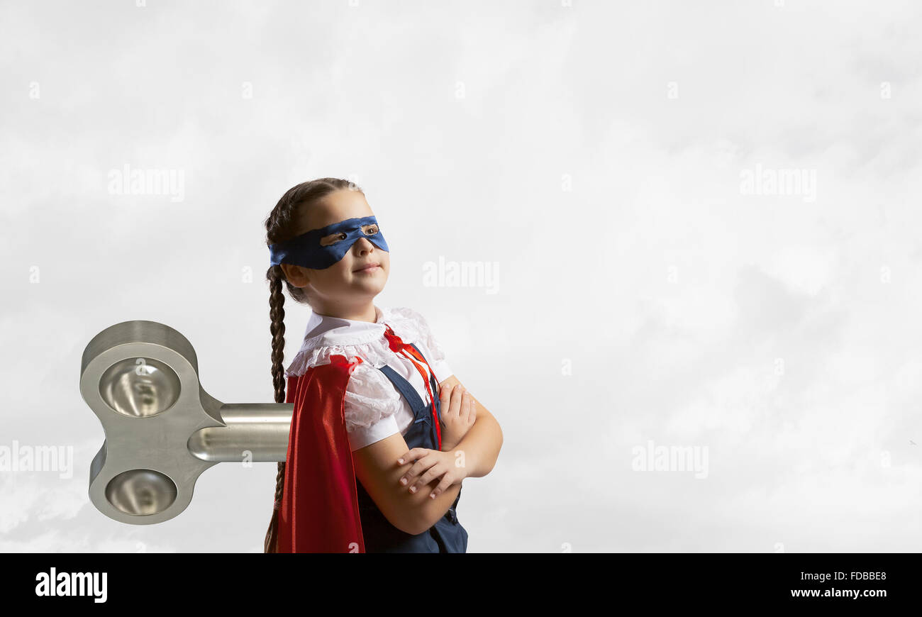 Little cute active girl with key on back Stock Photo - Alamy