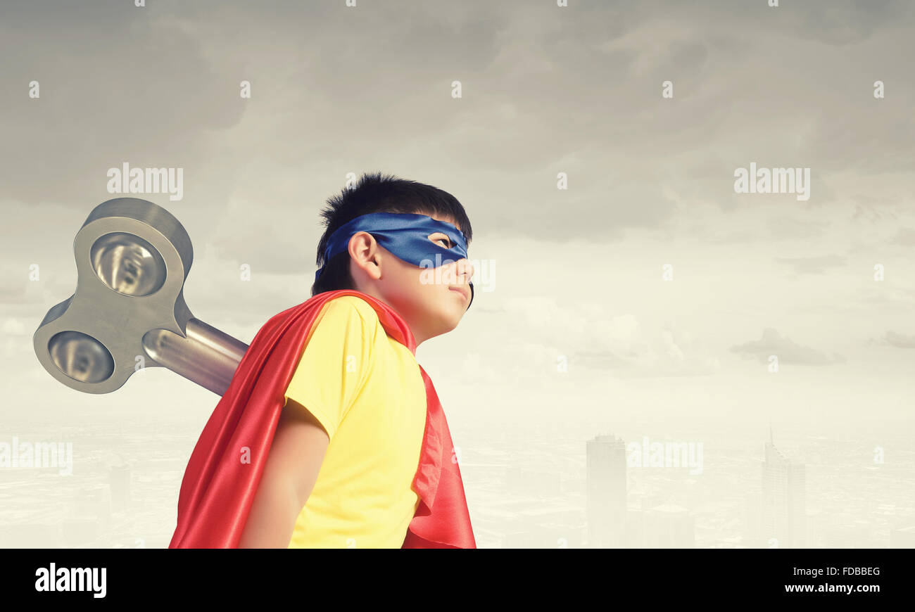 Little super active boy with key on back wearing super hero costume ...