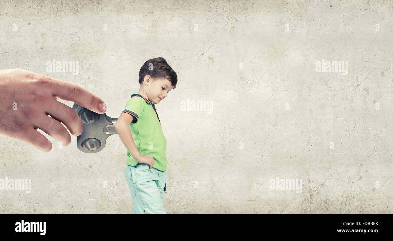 Little cute active boy with key on back Stock Photo - Alamy
