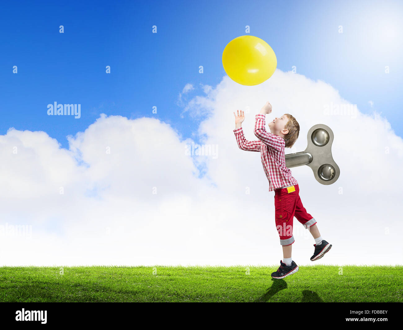 Little cute active boy with key on back Stock Photo - Alamy