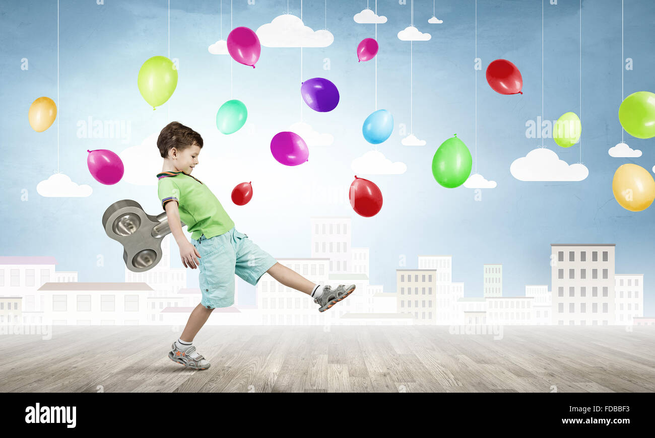 Little cute active boy with key on back Stock Photo - Alamy