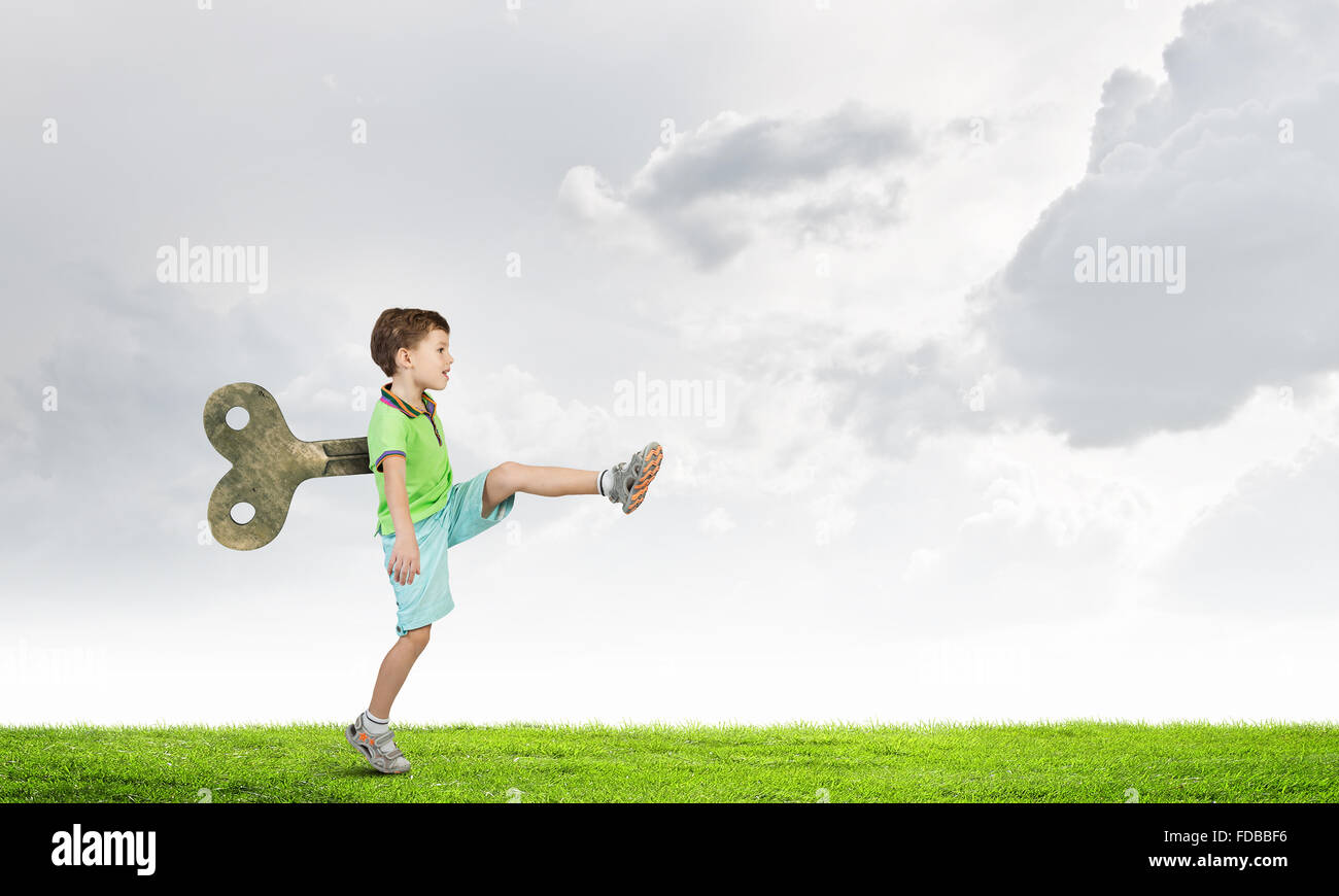 Little cute active boy with key on back Stock Photo - Alamy