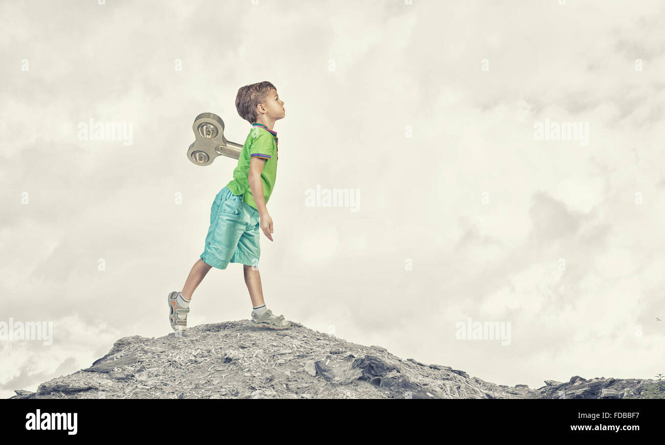 Little cute active boy with key on back Stock Photo - Alamy