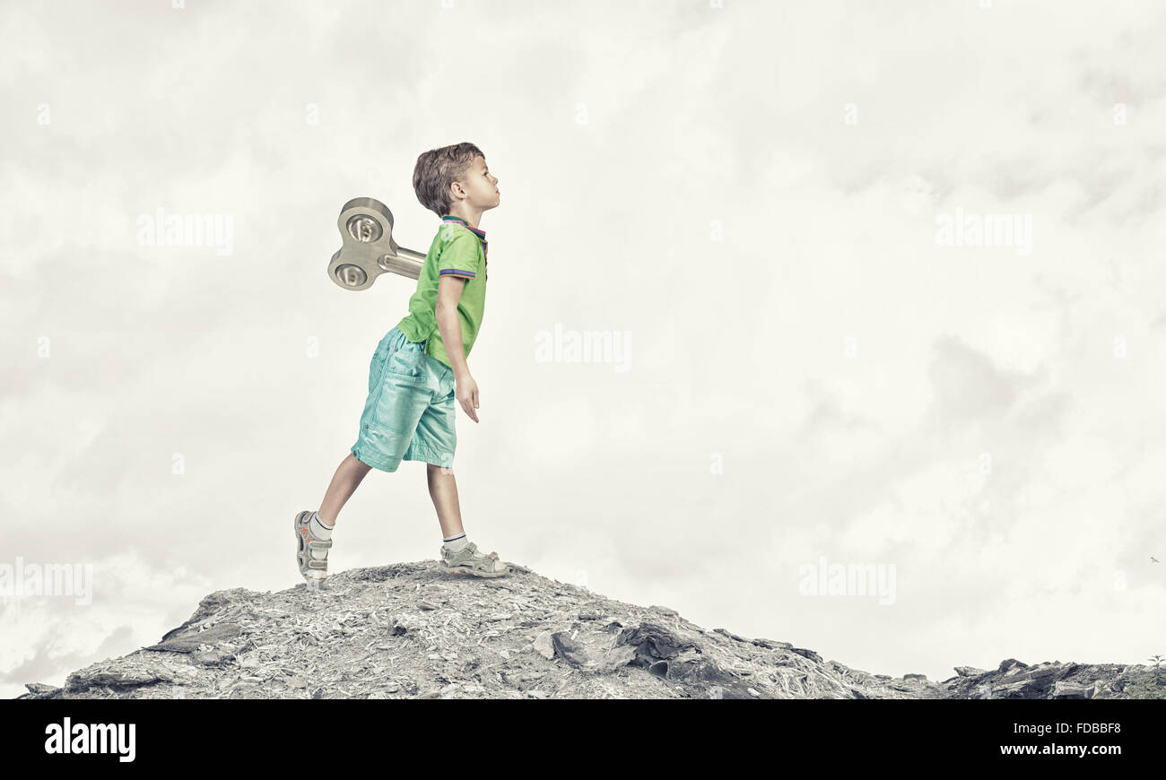 Little cute active boy with key on back Stock Photo - Alamy