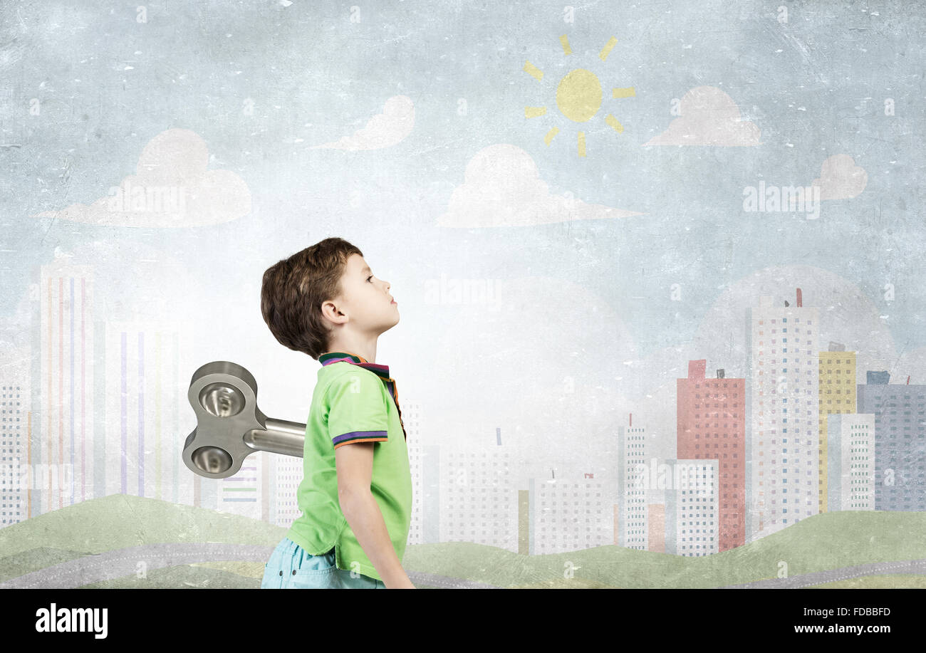 Little cute active boy with key on back Stock Photo - Alamy
